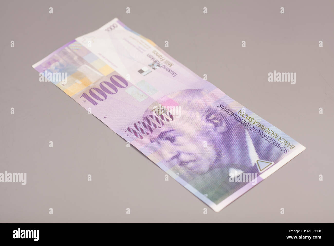 Swiss one thousand franc notes on a gray background Stock Photo - Alamy