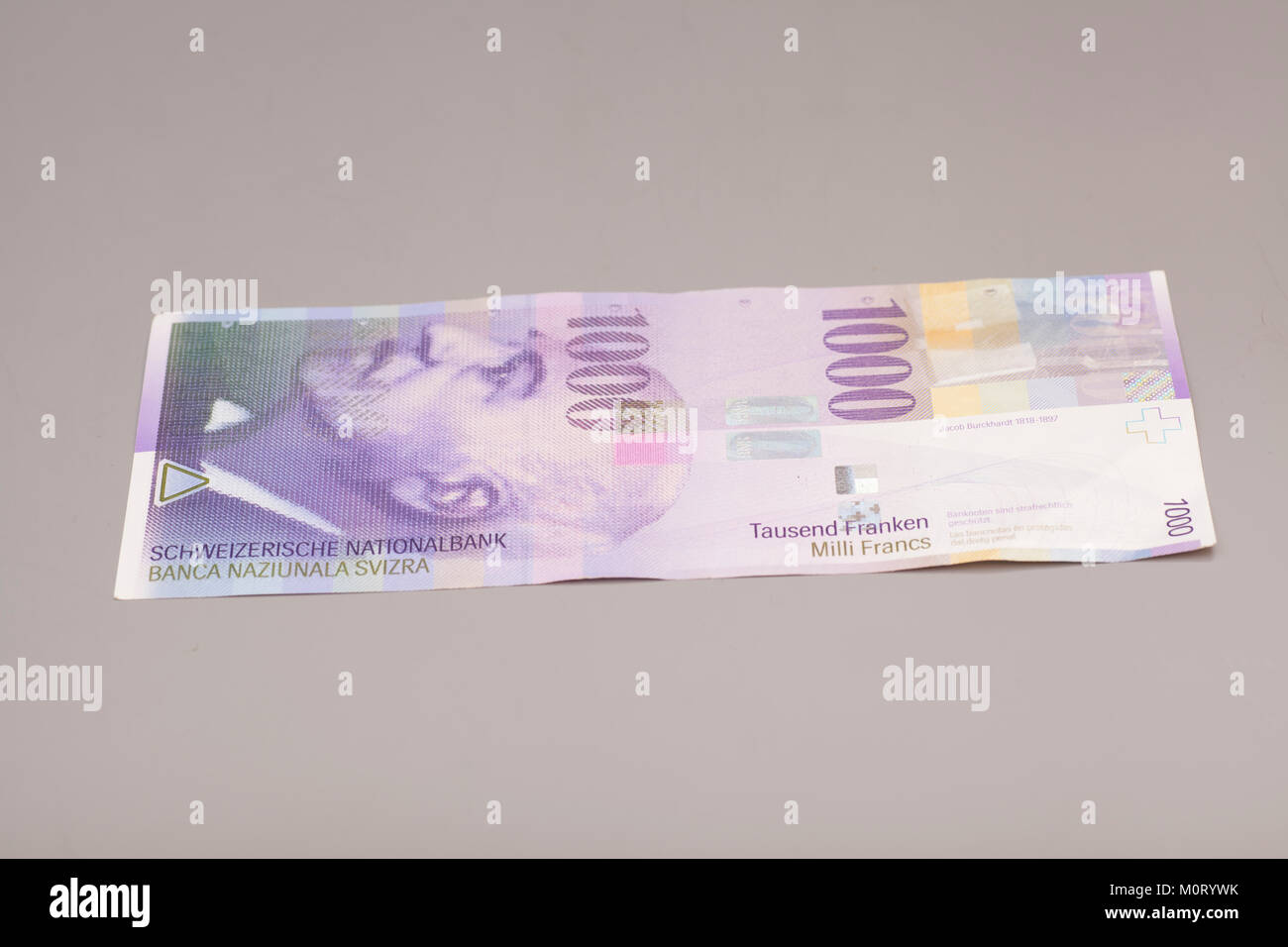 Swiss one thousand franc notes on a gray background Stock Photo - Alamy