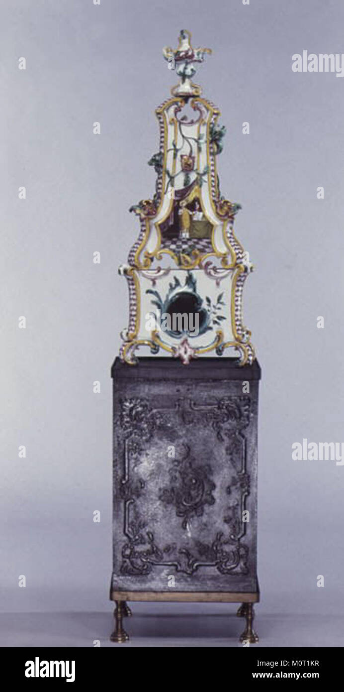 This ceramic stove with a cast-iron firebox, part of a pair, is part of ...