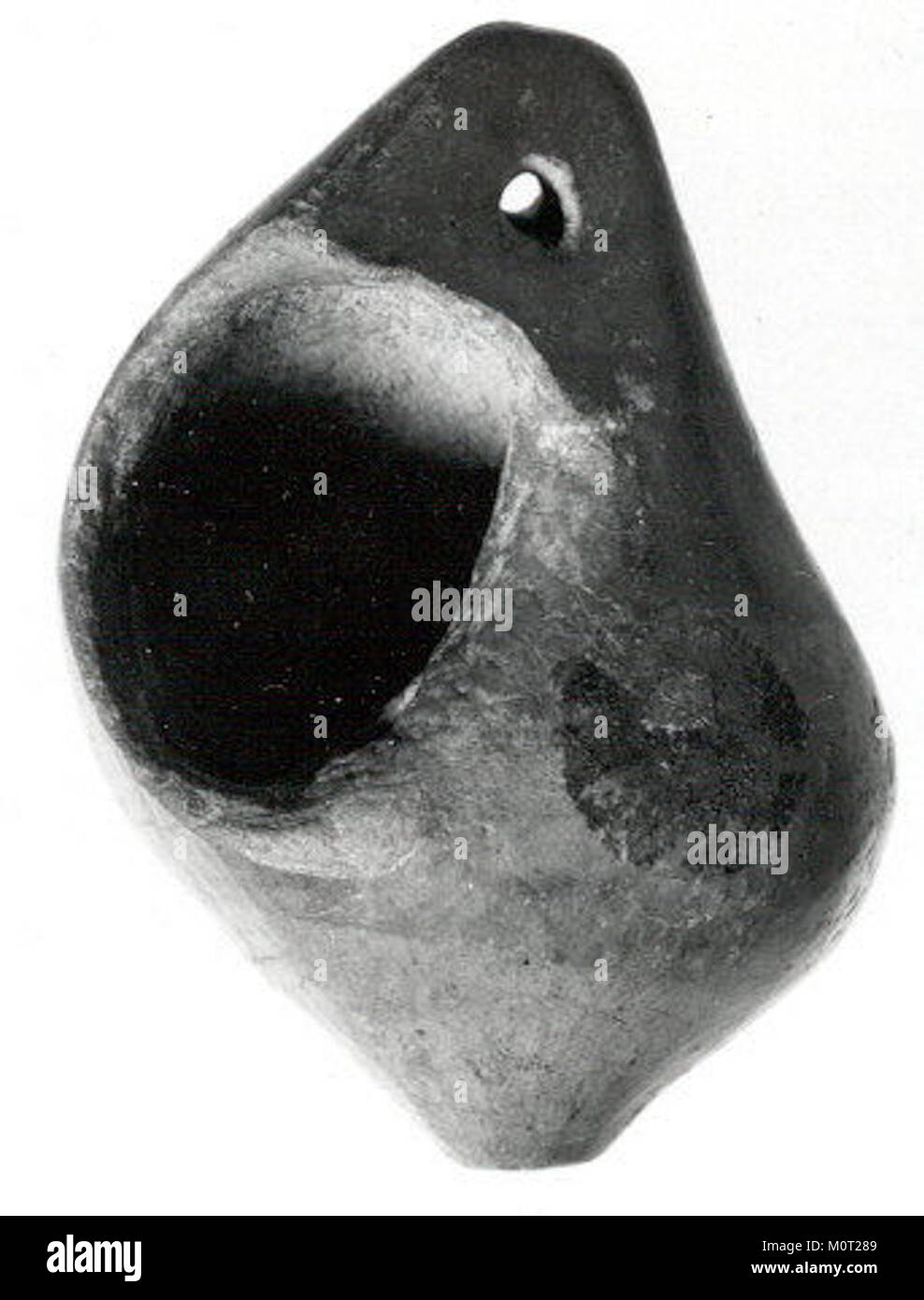 This ceramic whistle, in the form of a shell, is part of the ...