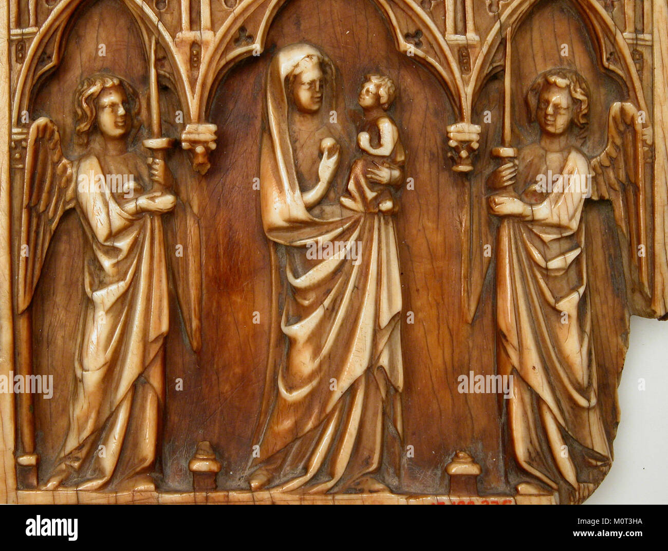 This artwork, part of a triptych, depicts the Crucifixion and the Virgin and Child, showcasing ...