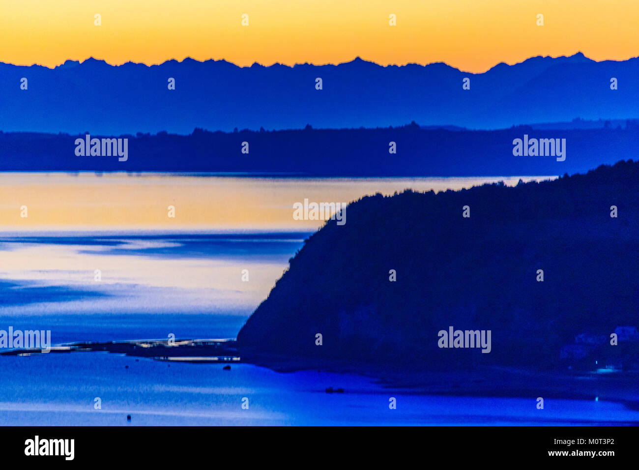 Sunset landscape scene with fjord and mountains as main subject, Chiloe ...