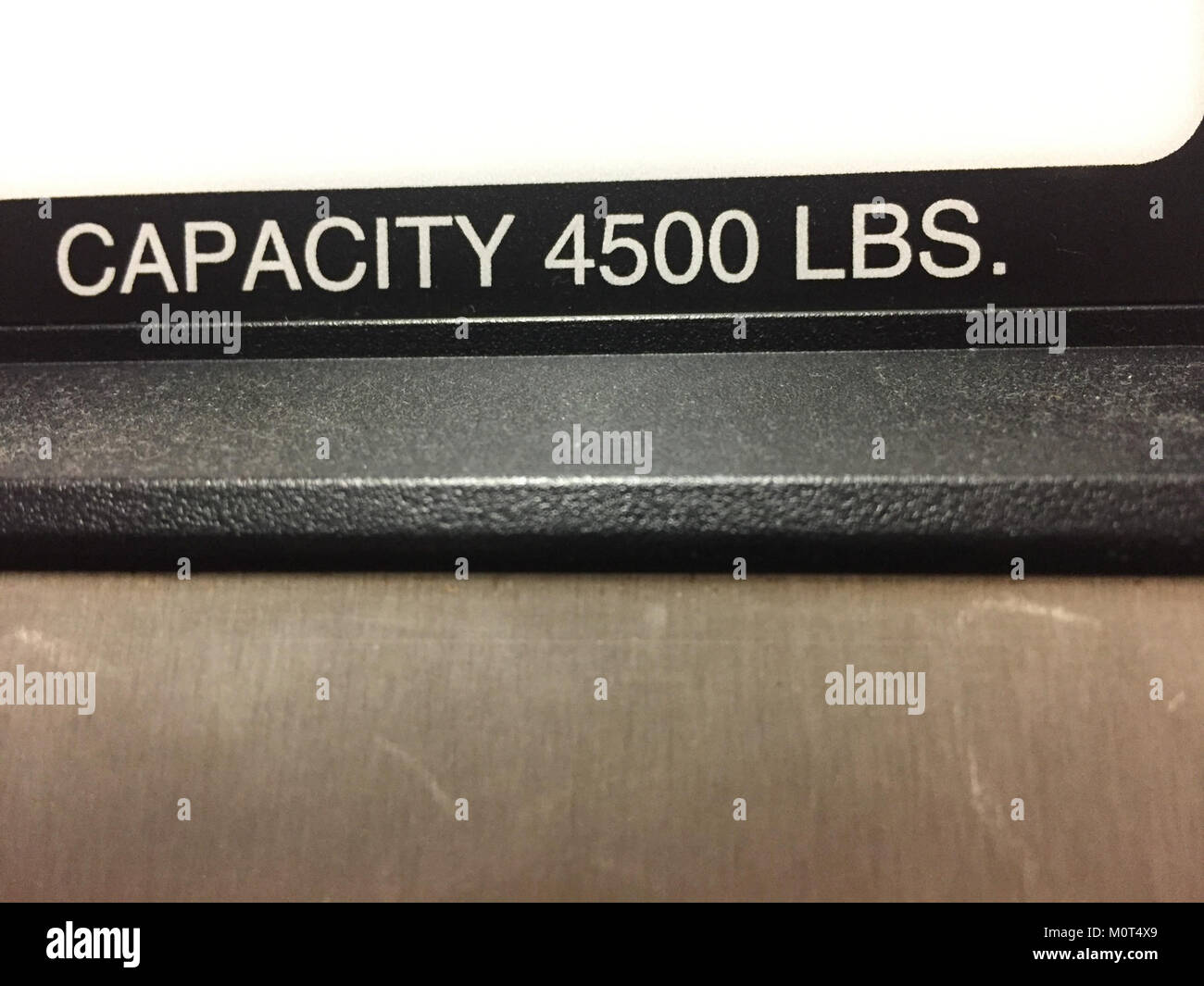 A capacity sign in an elevator indicates the maximum number of ...