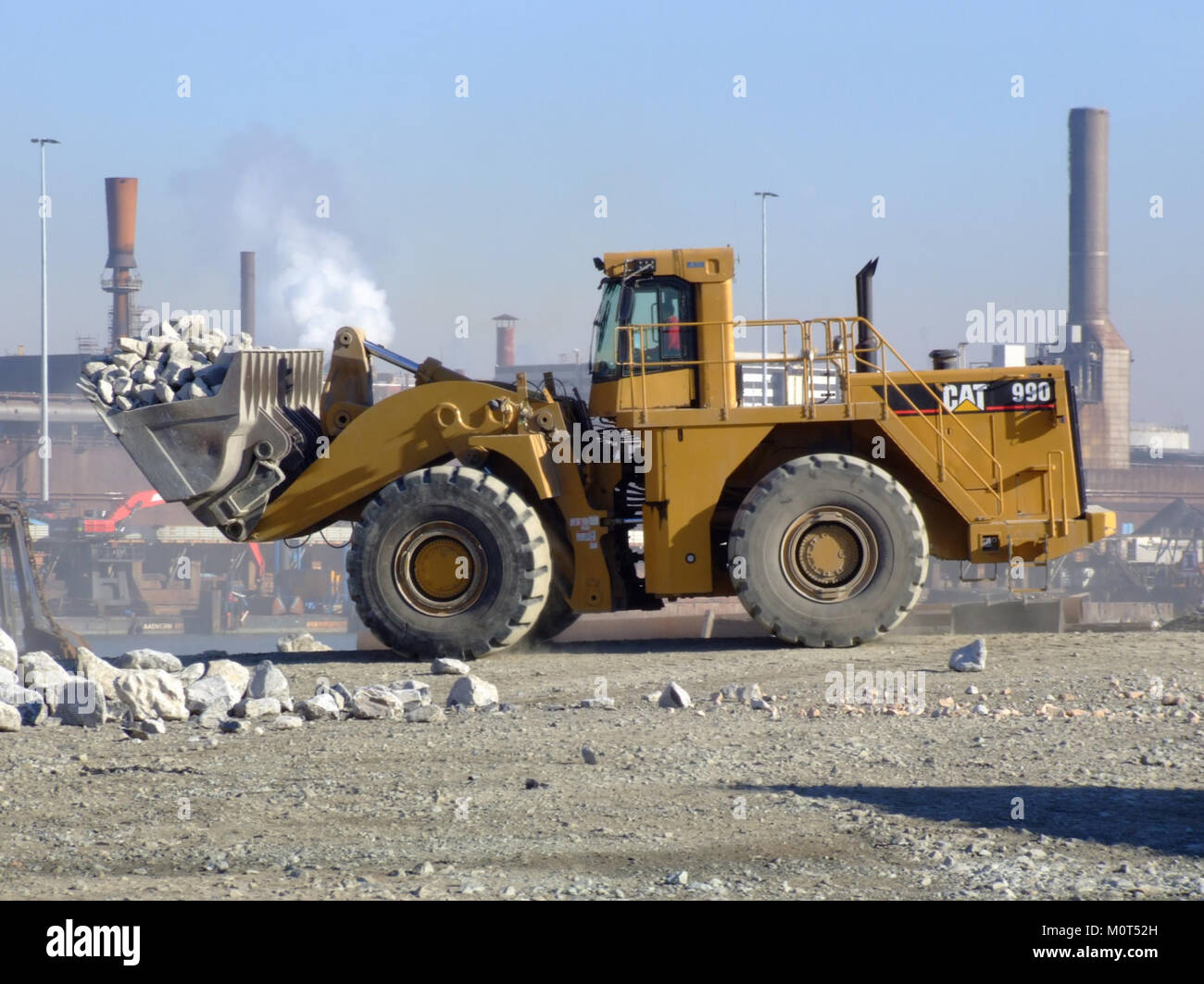 The CAT 990 is a large, industrial machine used for heavy-duty ...