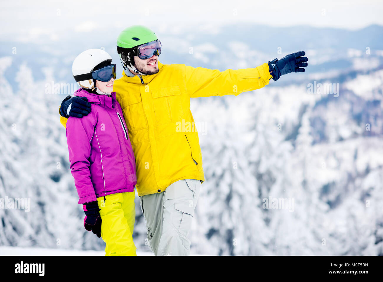 Couple in snowboarding clothes on the snowy mountains Stock Photo - Alamy