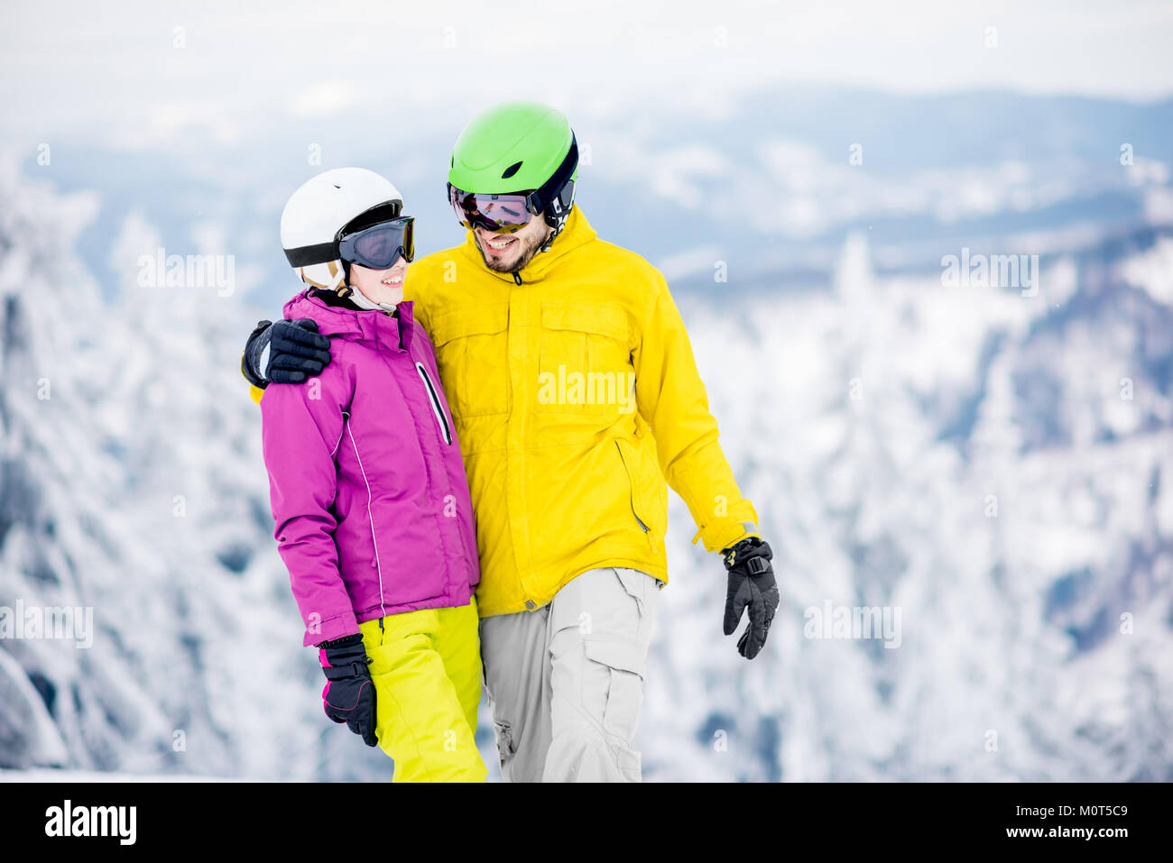 Couple in snowboarding clothes on the snowy mountains Stock Photo - Alamy