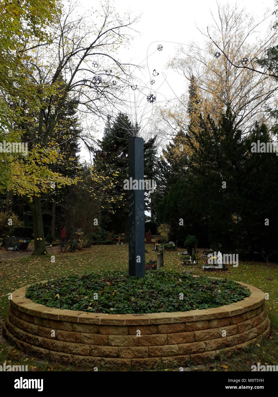 This image captures a cemetery in Apolda, Germany. The cemetery, marked ...