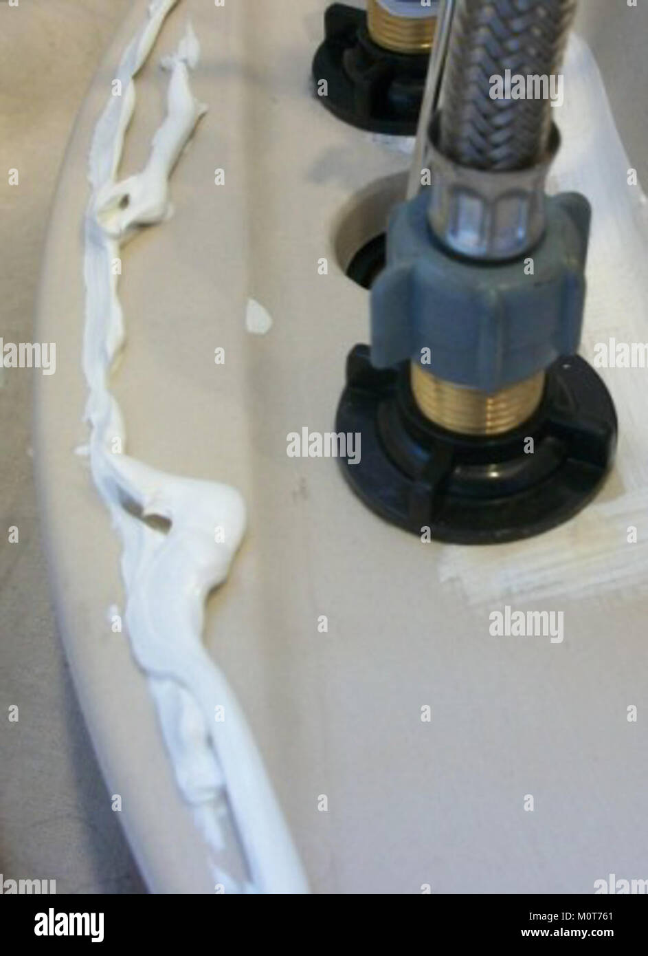 Caulking underneath the bathroom sink is an essential part of ...