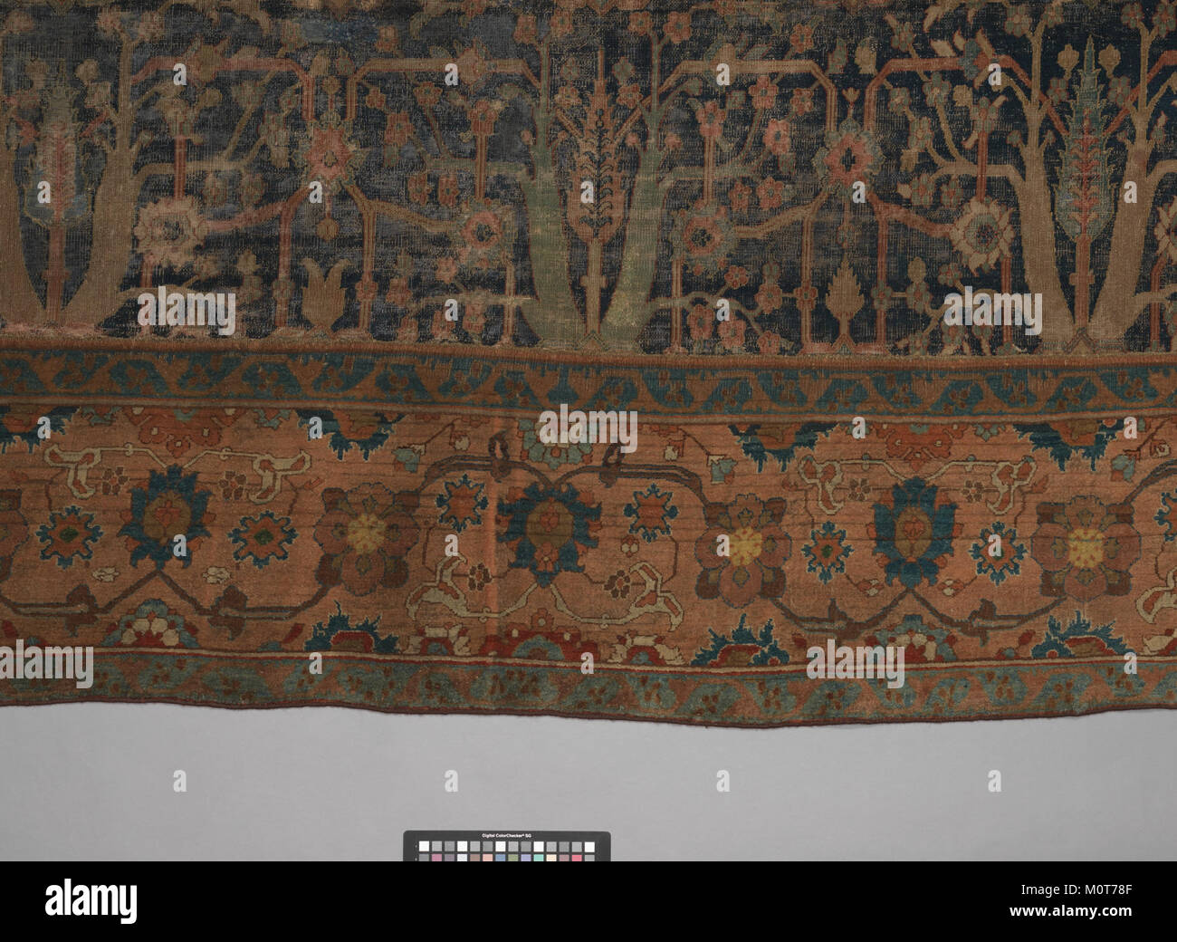 A carpet featuring a repeating tree design, displayed at the ...