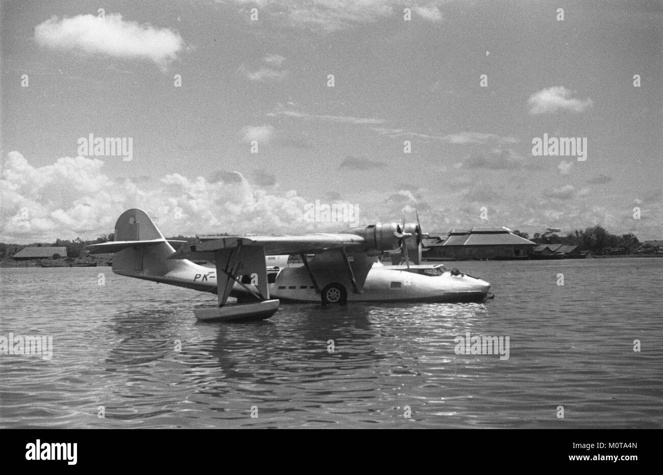 This image shows a Catalina flying boat floating on a river. The ...