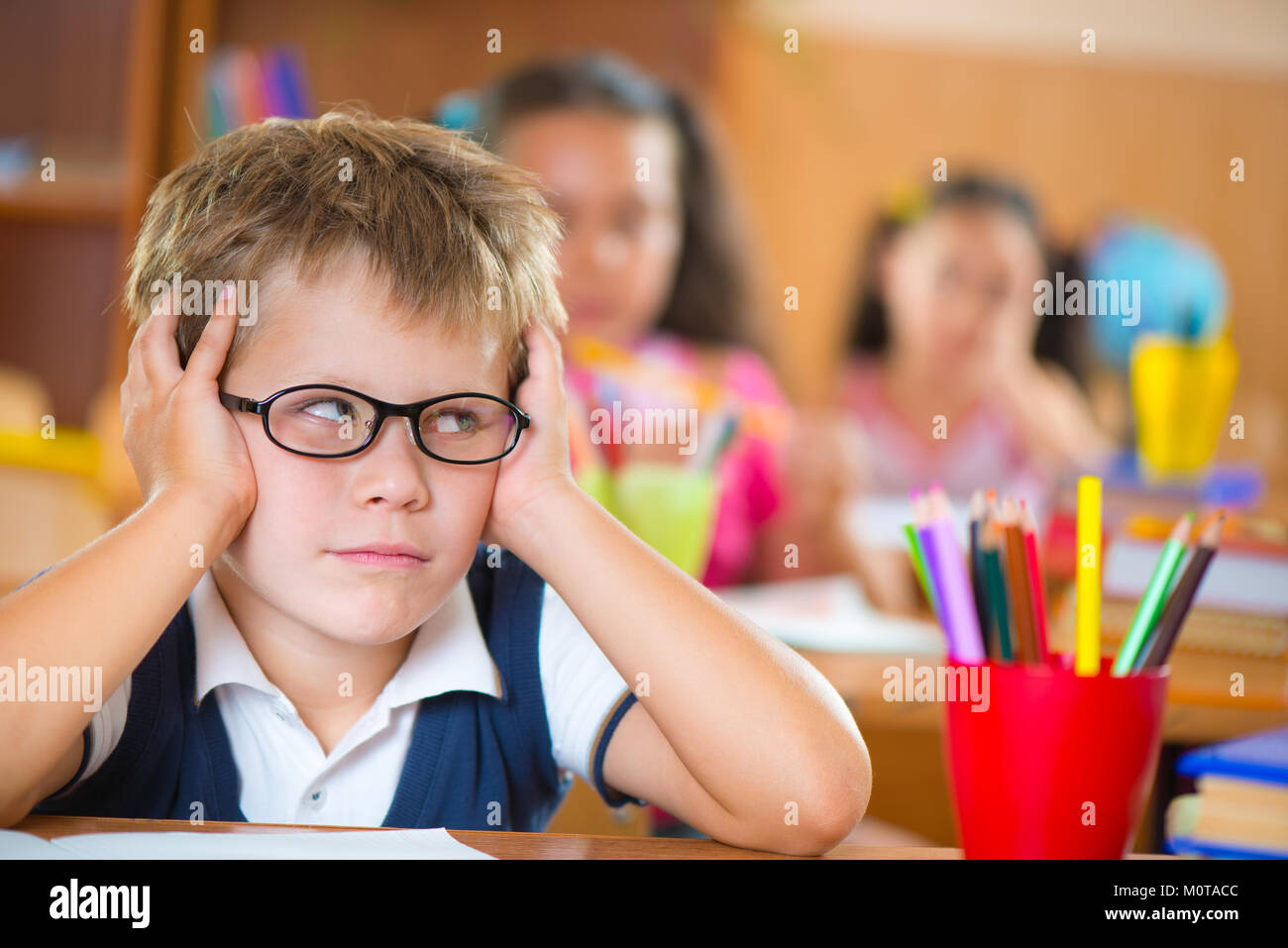 Happy elementary students in classroom at school Stock Photo - Alamy
