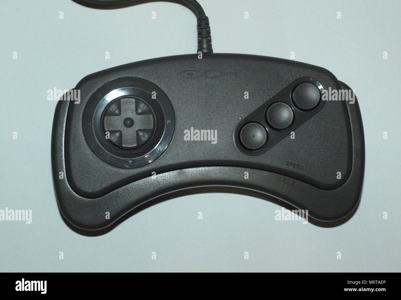 A CD-i GamePad, photographed in flash, is an early video game ...