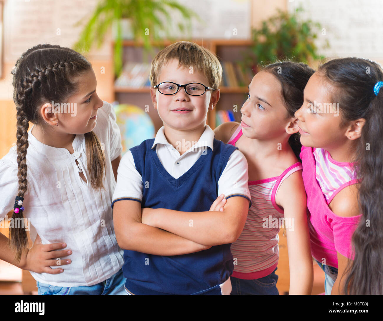 Happy elementary students in classroom at school Stock Photo - Alamy
