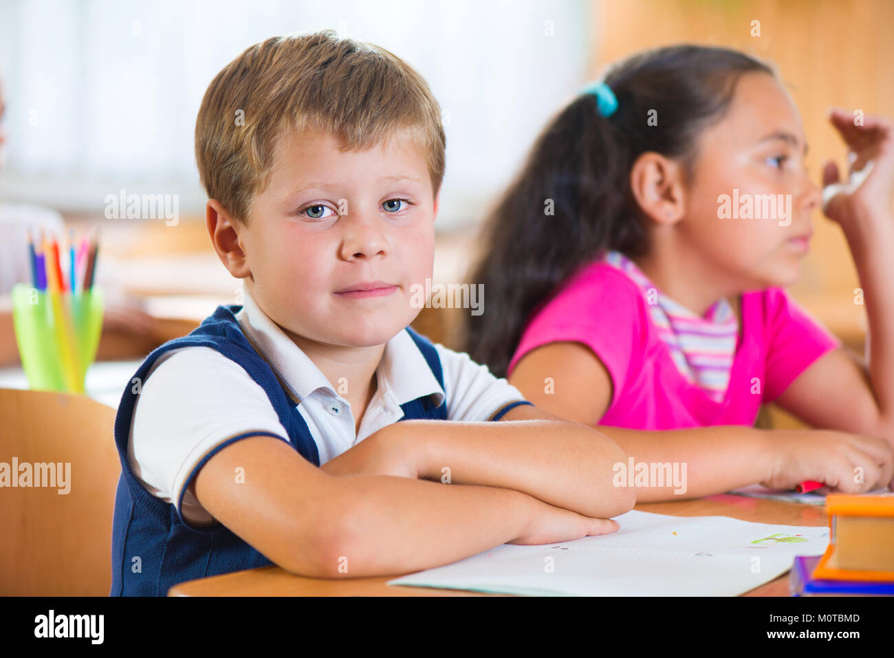 Happy elementary students in classroom at school Stock Photo - Alamy