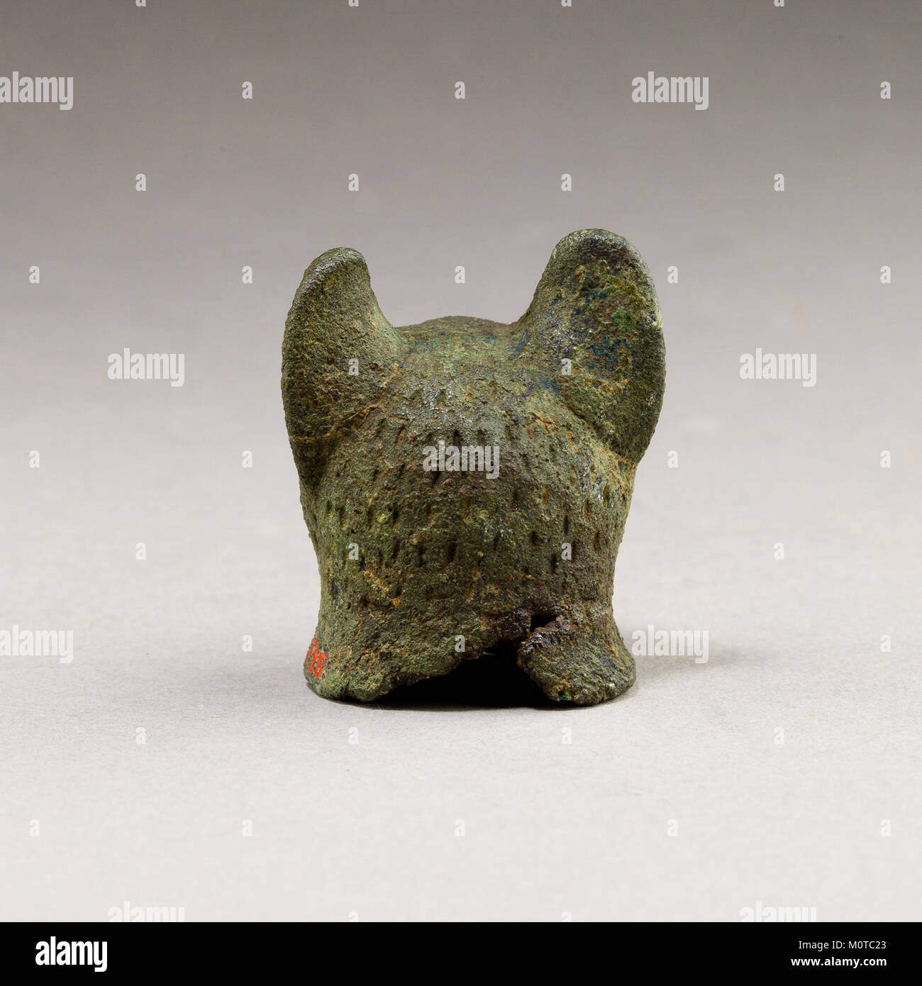 A detailed artifact representing a cat head, likely an ancient ...