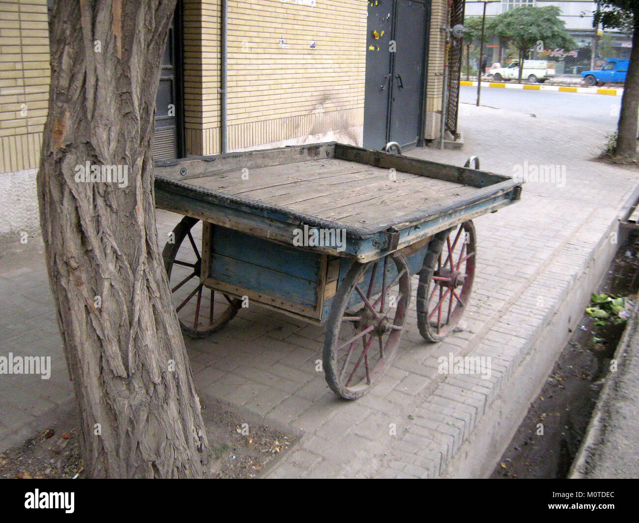 This photograph depicts a cart on the sidewalk of Christ Street in ...
