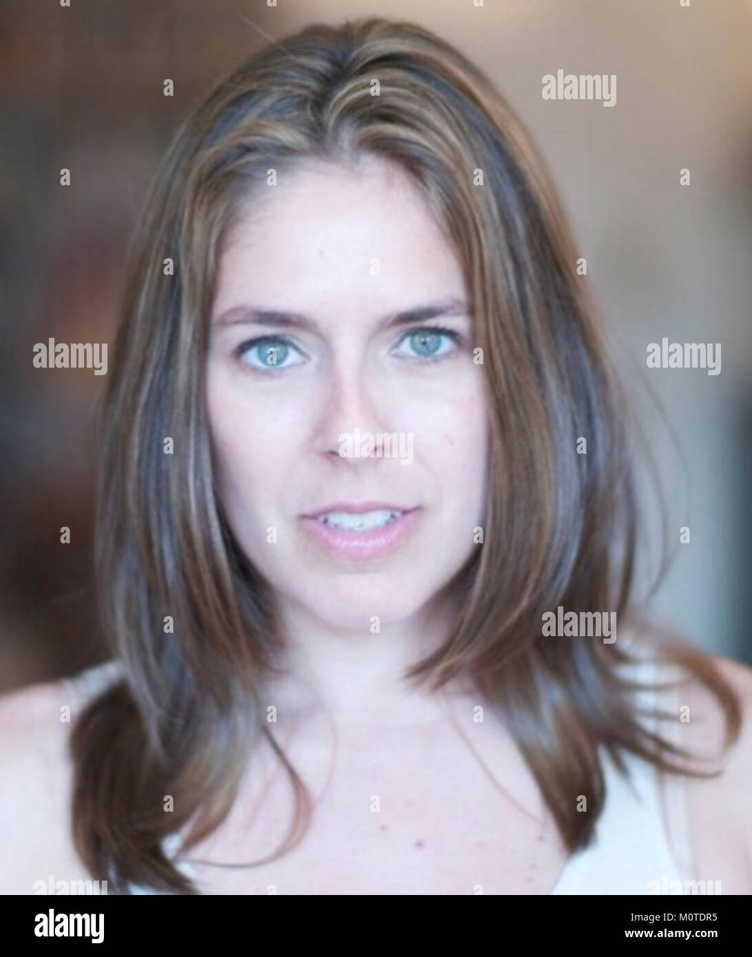 A professional headshot of Carlin Ross, likely a public figure or ...