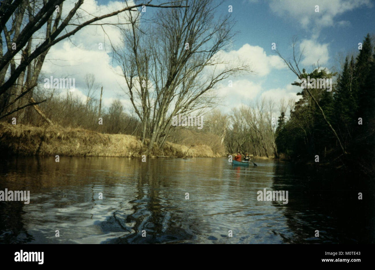 The 'Canoeing Spirit River 1994' photograph captures a serene moment of ...