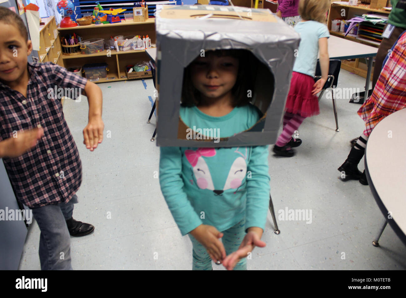 The photograph features children at a preschool under CDSA, capturing ...