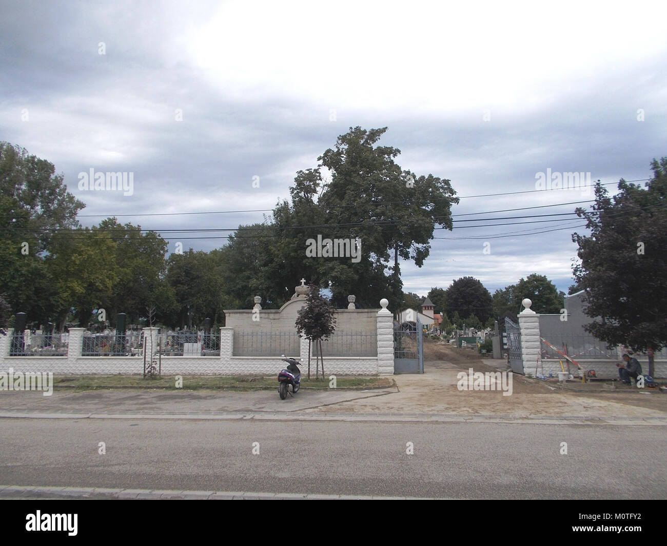 This image depicts a cemetery in Vecses, Hungary. The cemetery serves ...