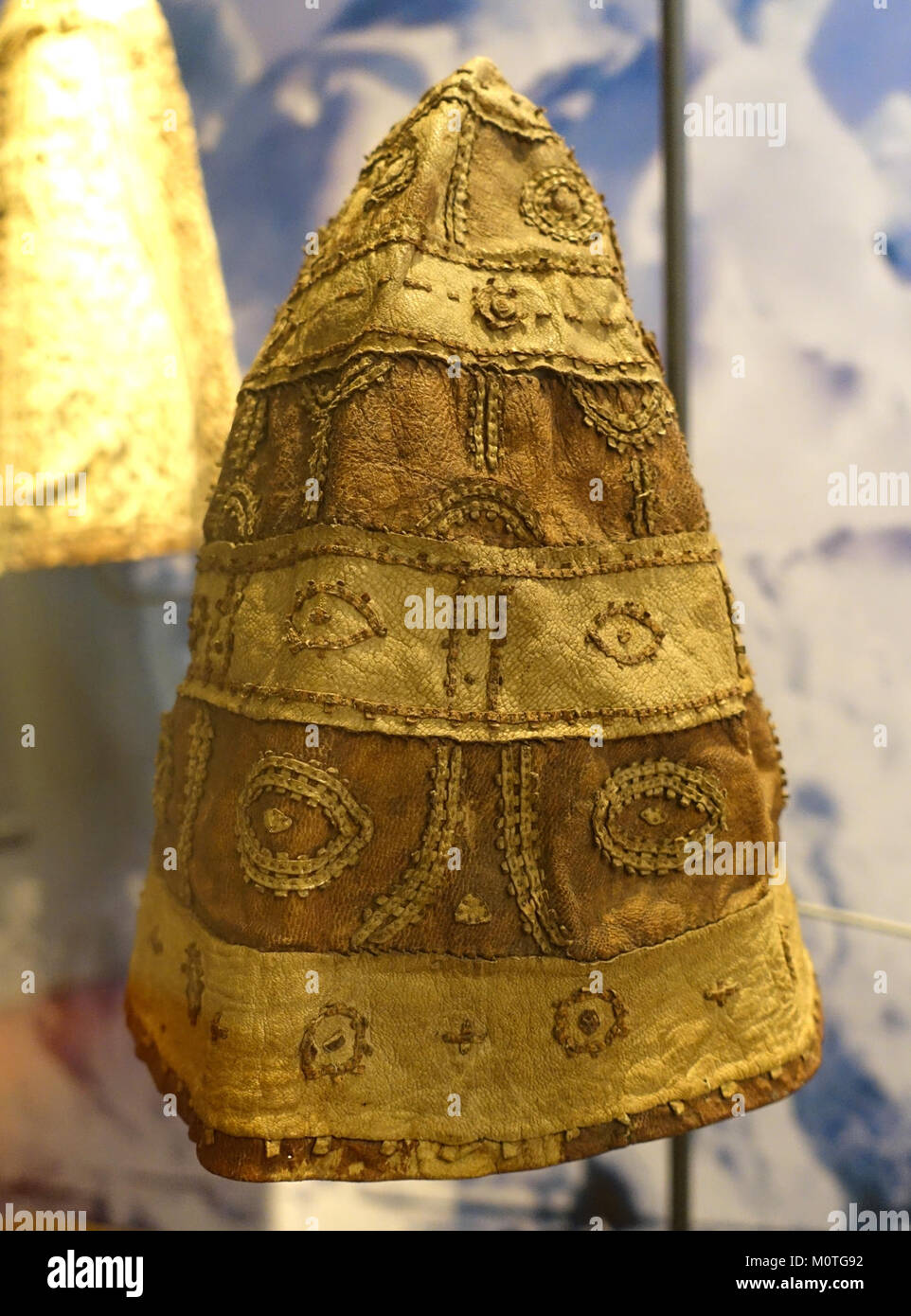 This leather cap, painted in traditional designs, originates from East ...