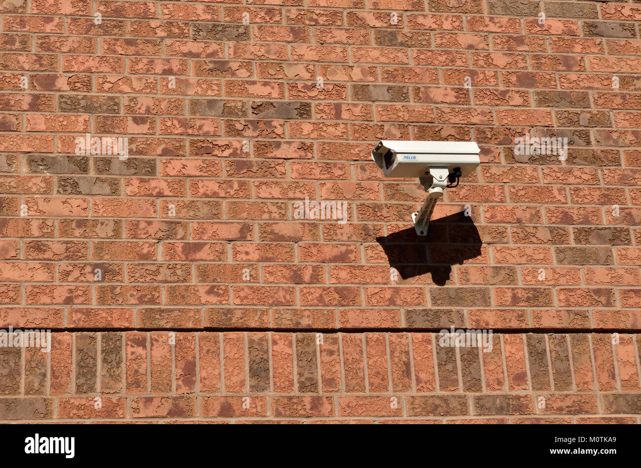 This image shows a brick wall with CCTV cameras mounted, symbolizing ...