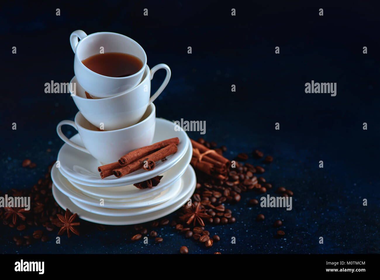 Header with a stack of balancing white coffee cups and tea saucers ...