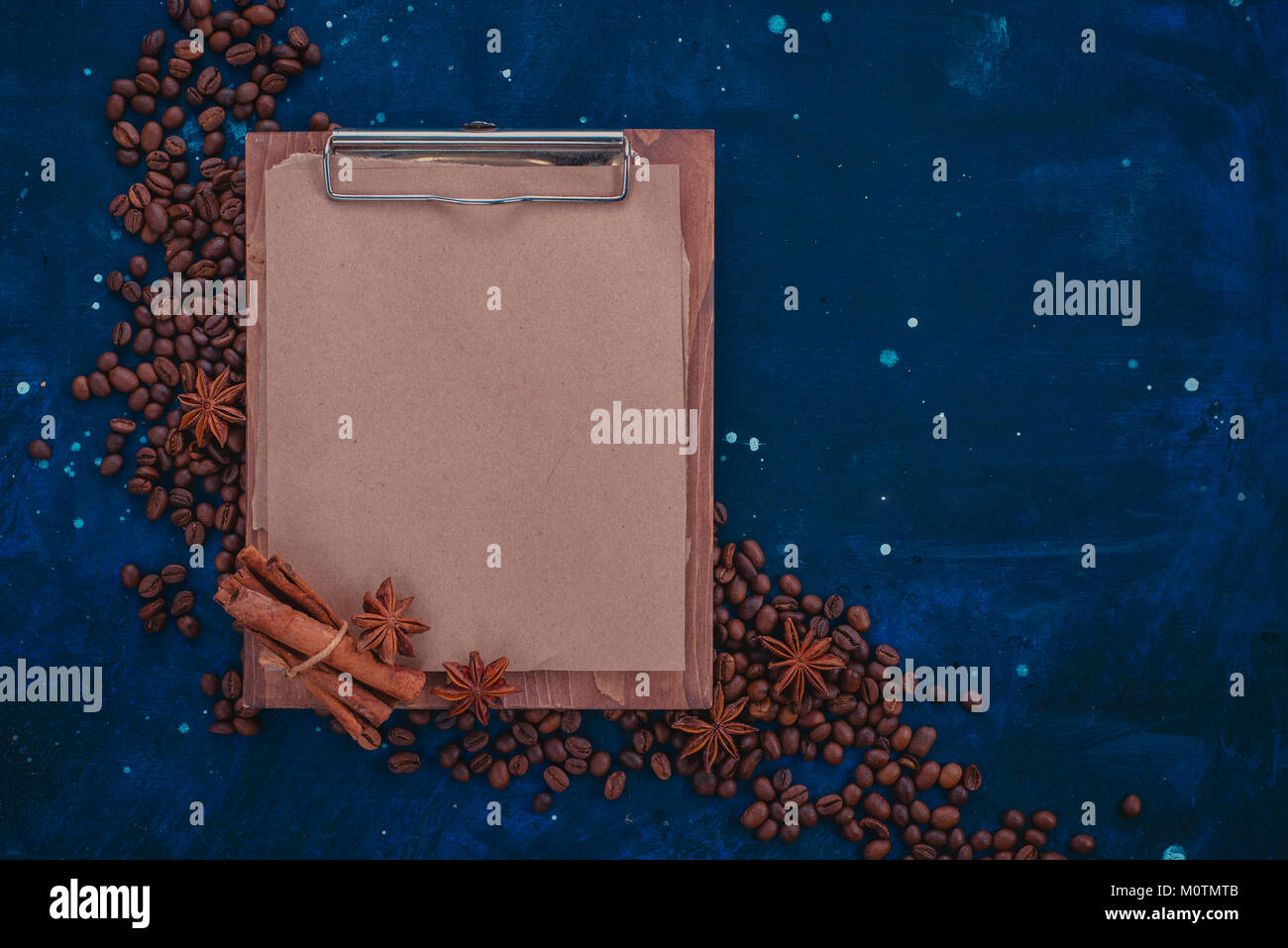 Blank wooden clipboard with craft paper in a header with coffee beans ...