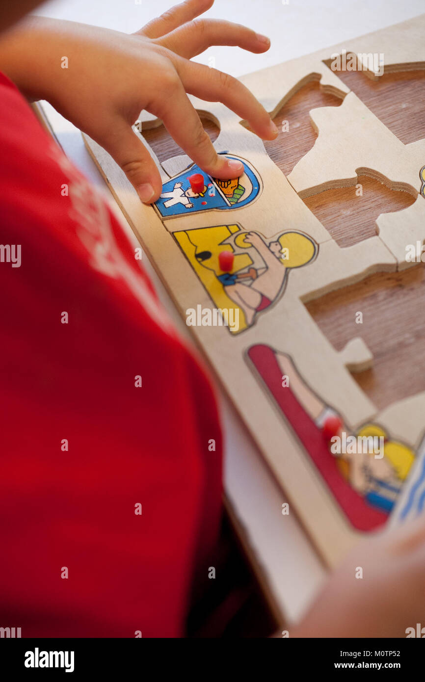 Child doing a puzzle at a kindergarten Stock Photo - Alamy