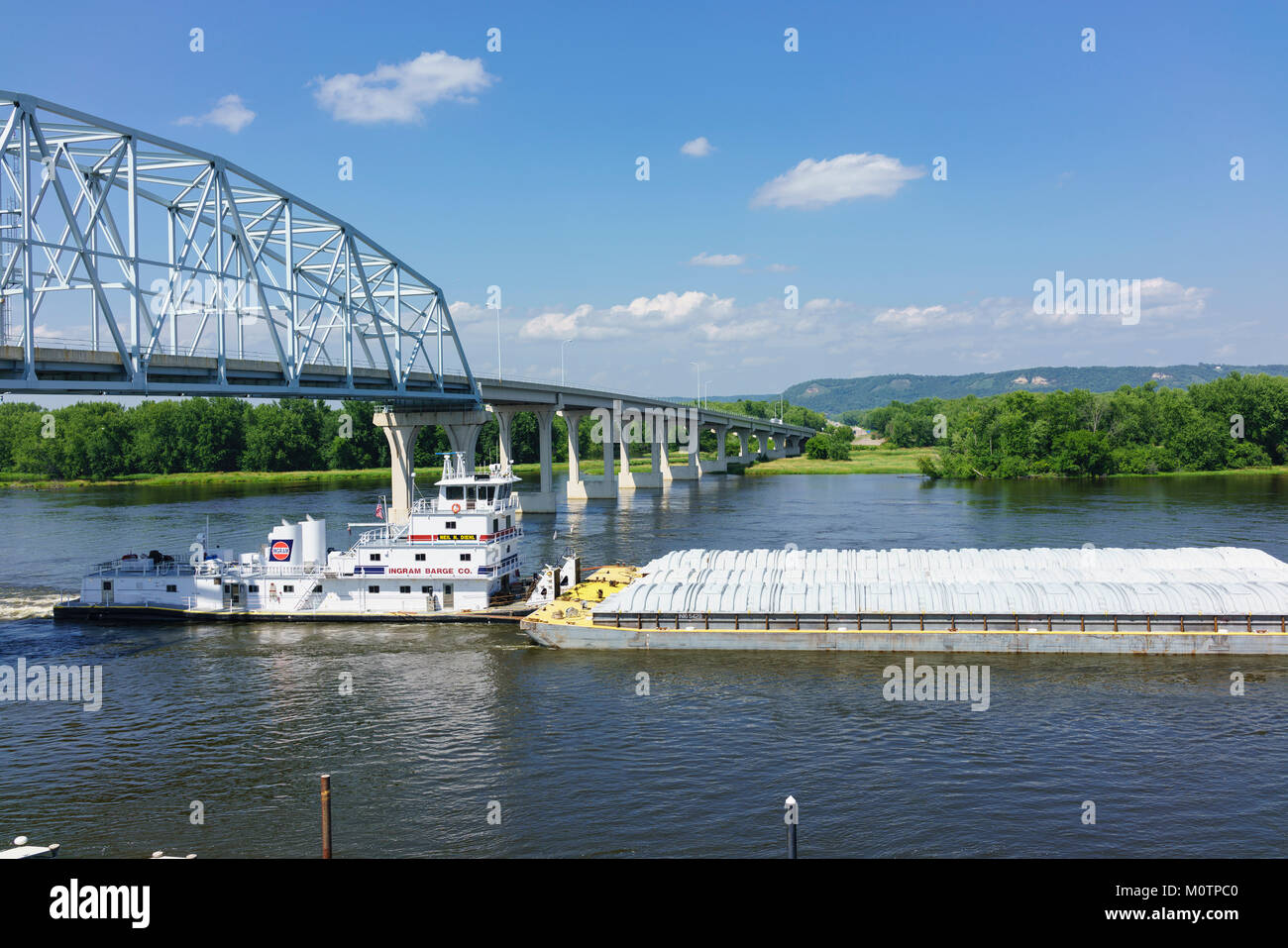 Tug boat pushes barges south on Mississippii RIver under Wasbasha ...