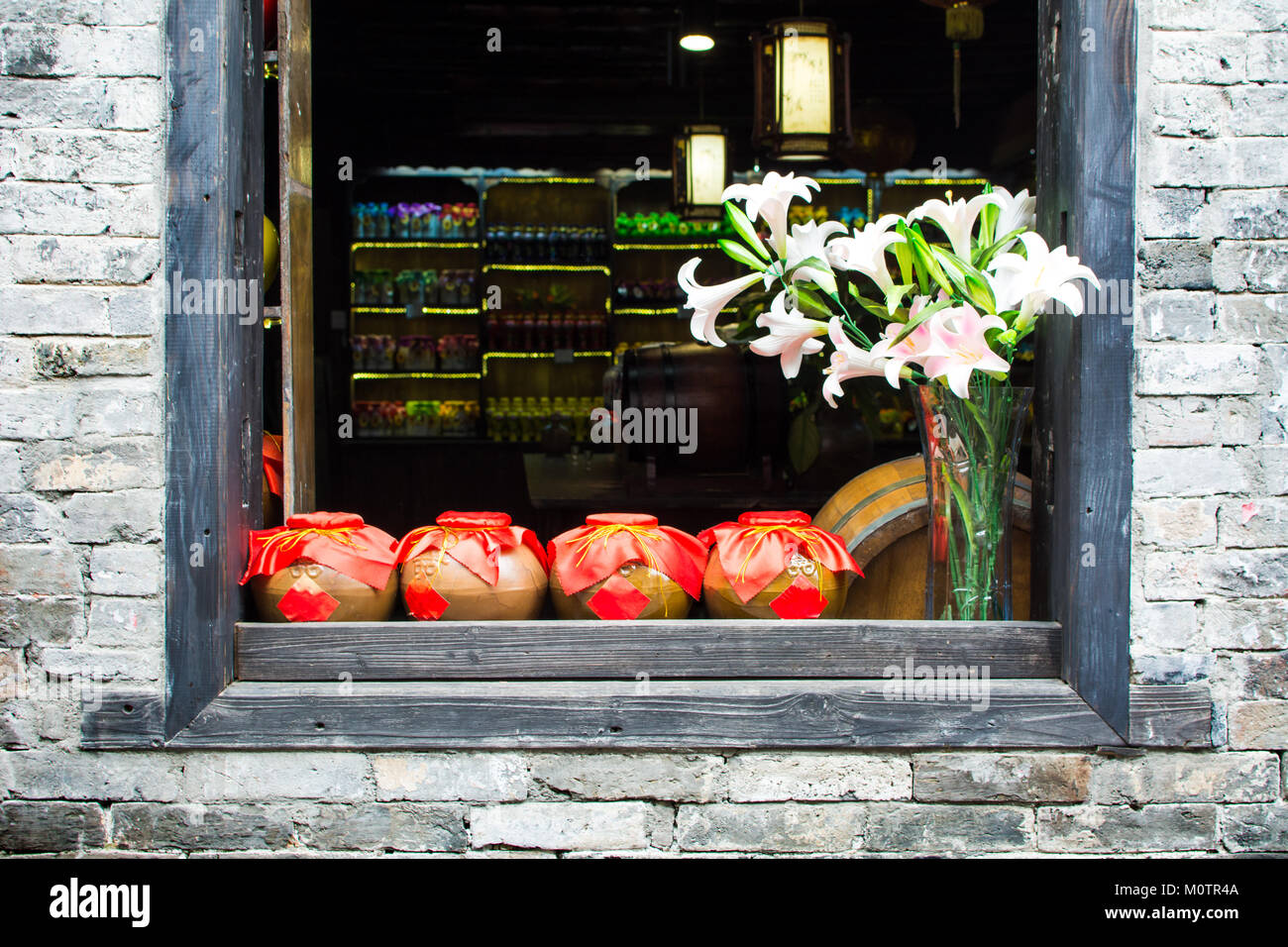 Chinese wine fermented with osmanthus flowers in traditional vats on ...