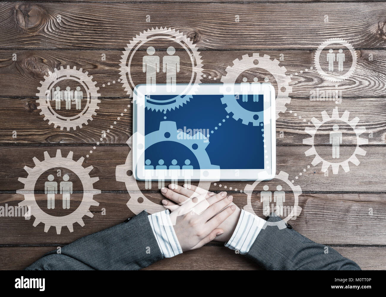 Concept of teamworking and connection with gears mechanism and tablet ...