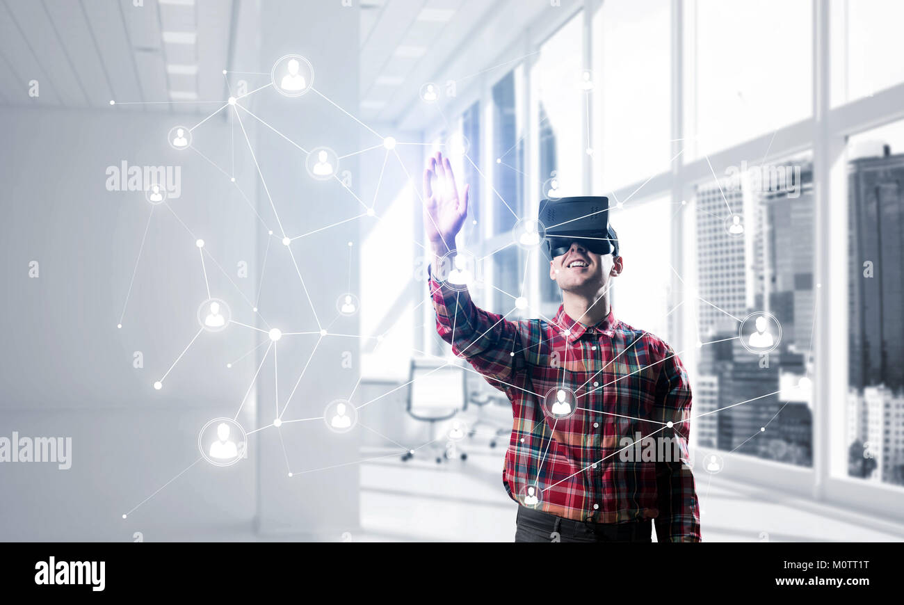 Guy wearing checked shirt and virtual mask reaching hand to touch ...