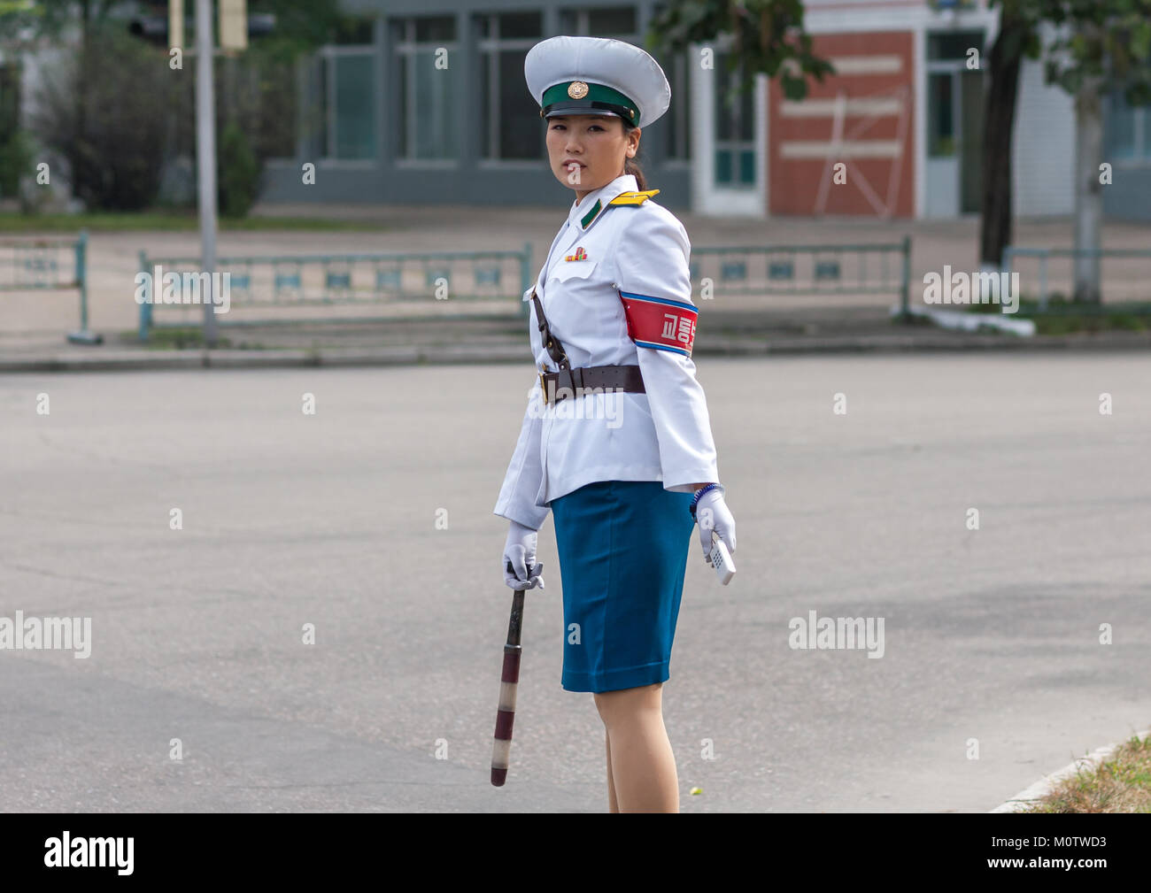 North Korean female traffic security officer in white uniform in the ...