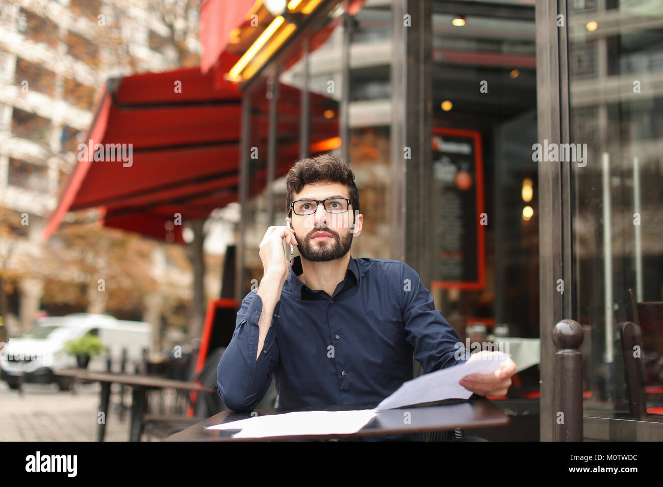 Real estate agent talking with client by telephone at cafe table Stock ...