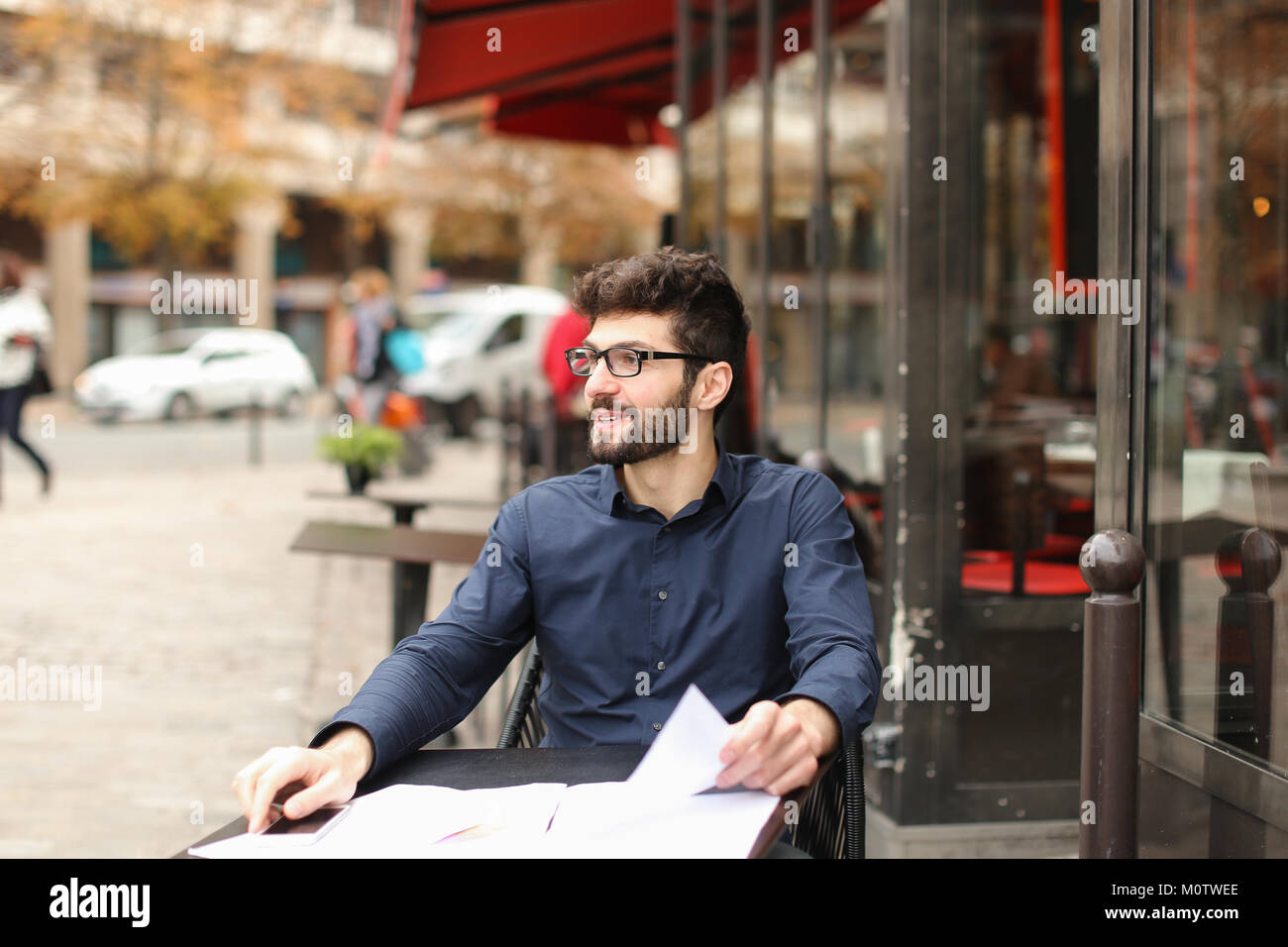 Fresh account manager working with papers and tablet at cafe tab Stock ...