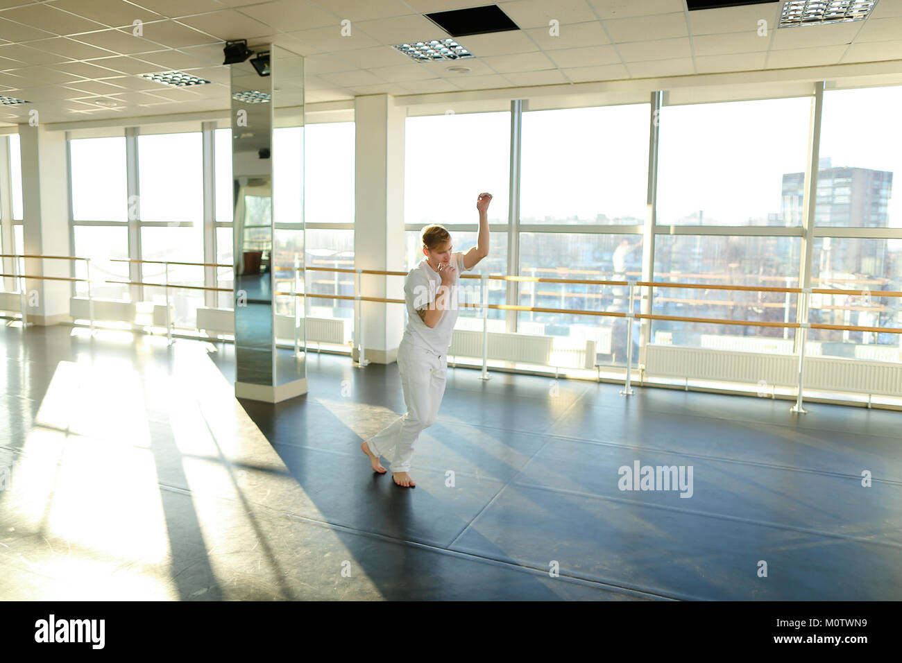 Blonde guy spotting at studio Stock Photo - Alamy
