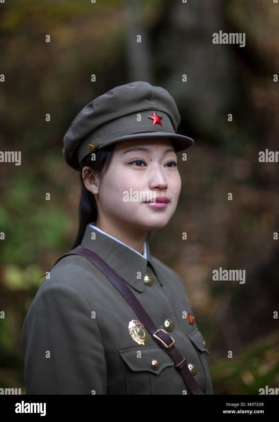 Portrait of a cute North Korean guide in military style uniform ...