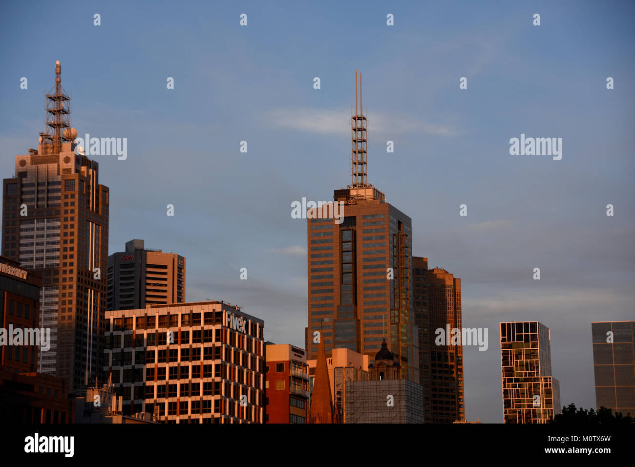 The Sun setting on the Buildings of Melbourne Stock Photo - Alamy