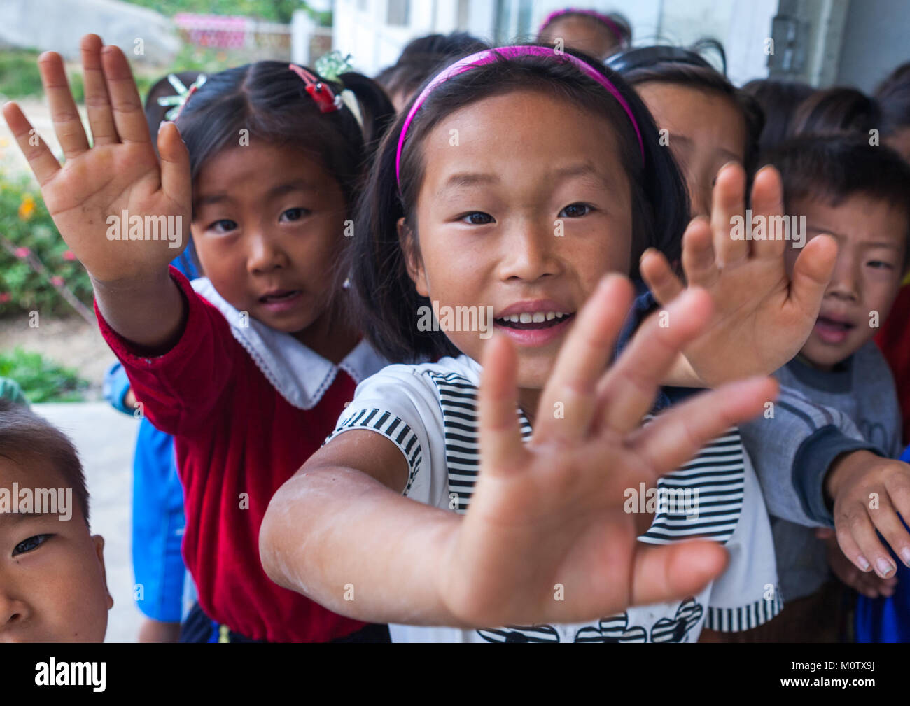 Group of North Korean children waving in a school, South Hamgyong ...