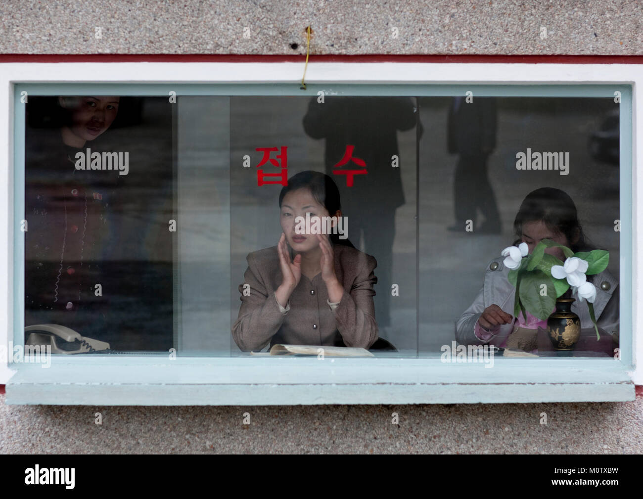North Korean women behind a ticket window in Pohyon temple, Hyangsan ...