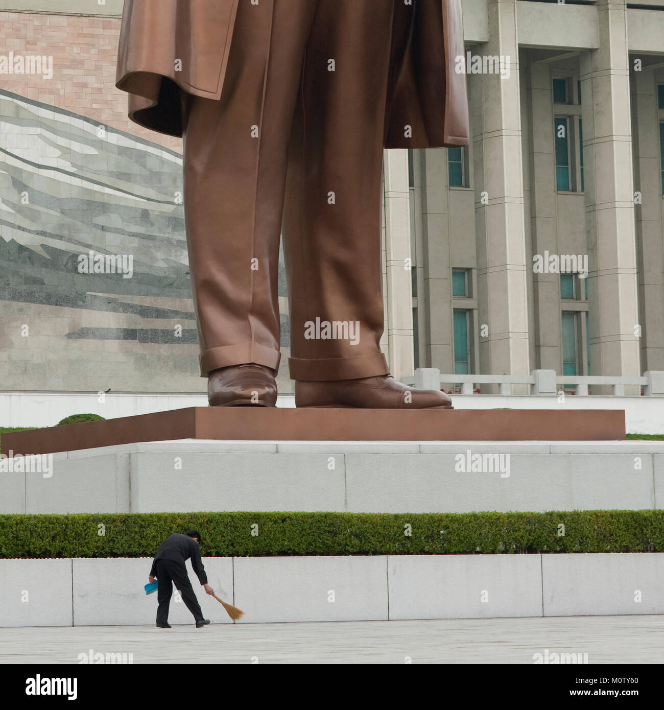 North Korean man sweeping in front of giant Kim il Sung statue in ...