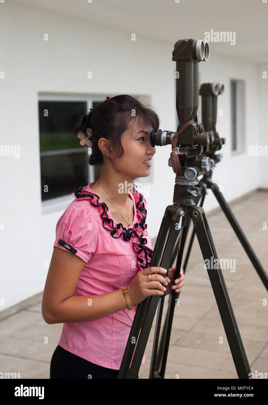 North Korean guide looking at south Korea from the wall section of the ...