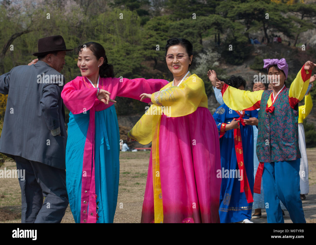 North Korean people dancing in a park for the day of the sun which is ...