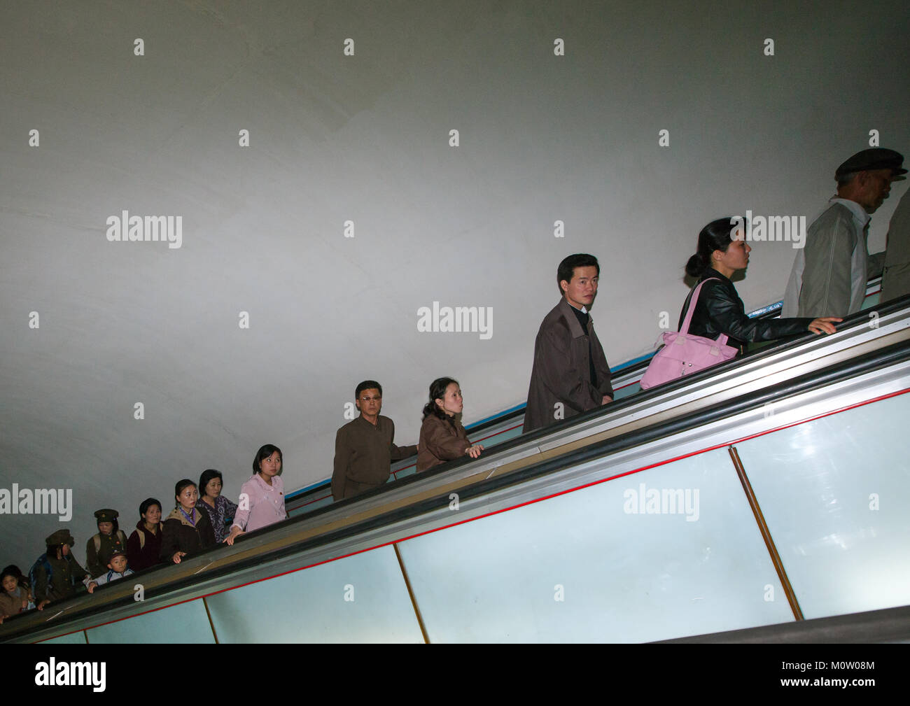 North Korean people using escalator leading to the subway station ...