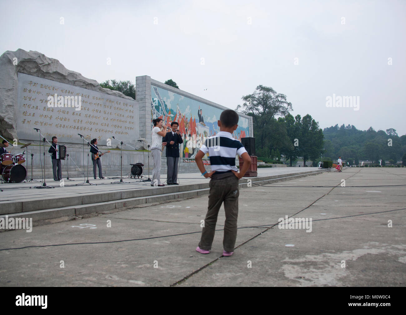 North Korean boy listening to a band playing music on national day in ...