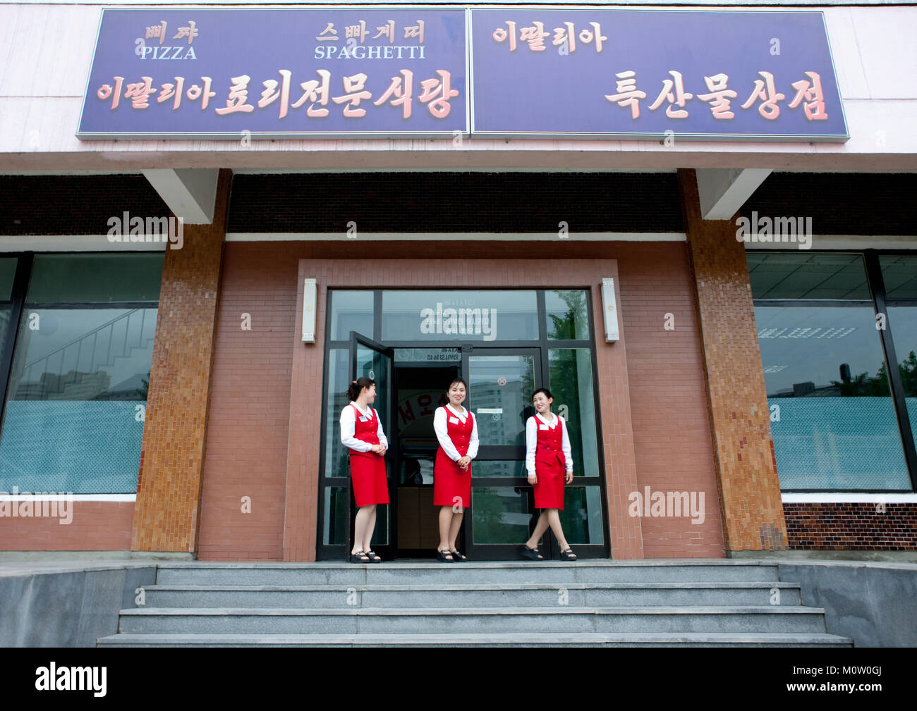 Pizzeria waitresses in front of an italian restaurant, Pyongan Province ...