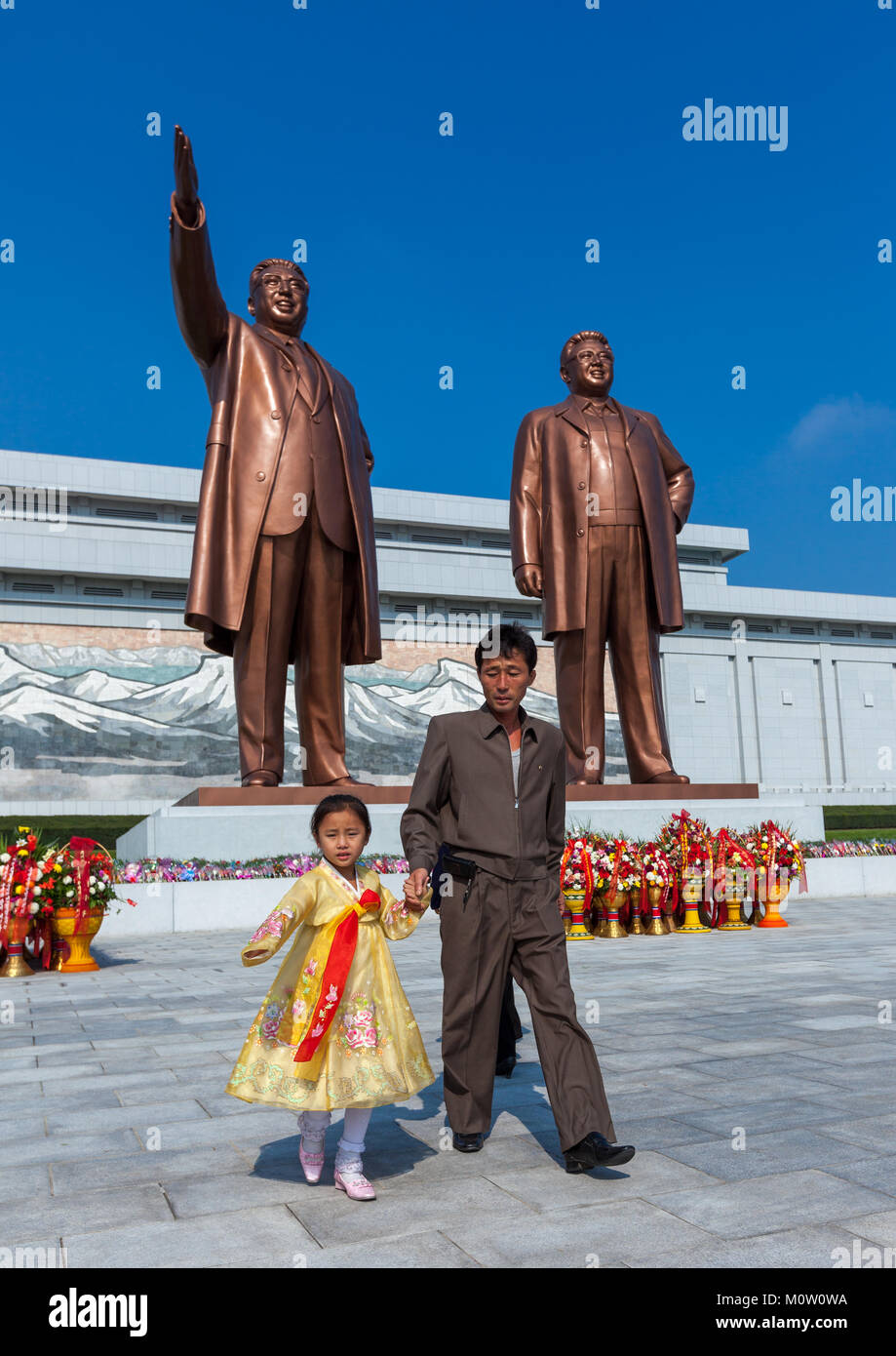 North Korean people in front of the statues of the Dear Leaders in ...