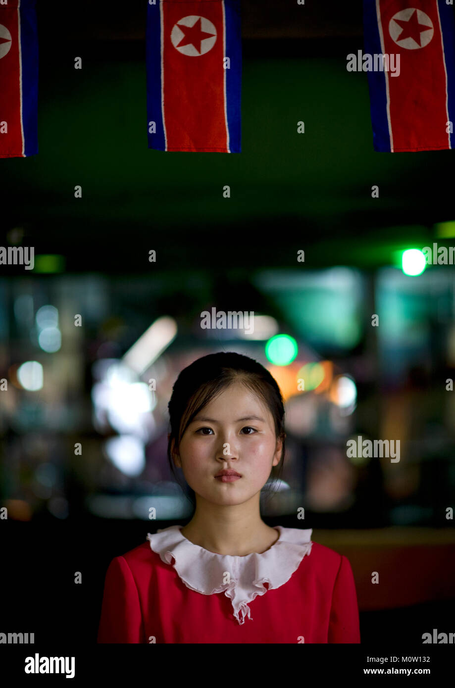 North Korean young woman under North Korean flags, Pyongan Province ...