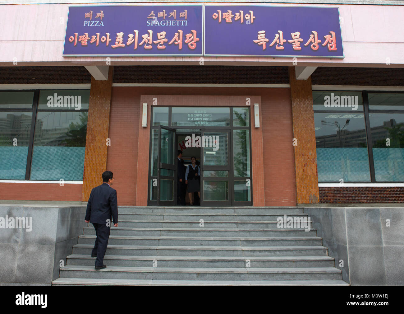 North Korean man entering a pizzeria restaurant, Pyongan Province ...